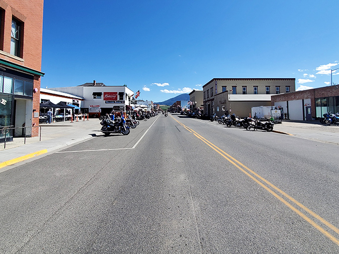 **Caption:**
Downtown Red Lodge buzzes with energy and mountain charm, where motorcycles, blue skies, and friendly faces fill the streets.