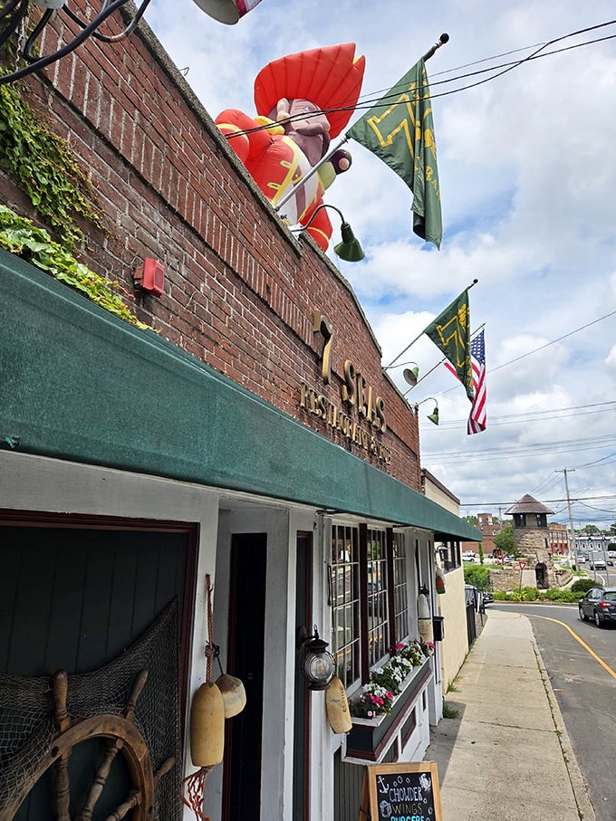 The whimsical sea captain figure watching over Seven Seas Restaurant. He's seen thousands of happy faces after their first lobster roll bite.