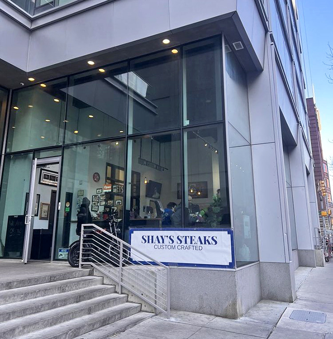 The modern storefront hides old-school dedication. Glass and steel outside, generations of tradition inside.