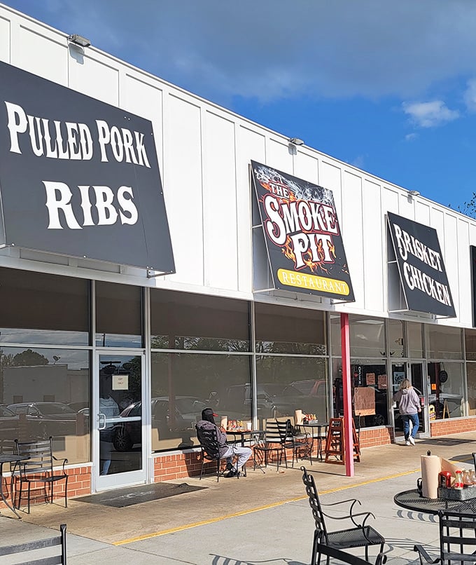 Texas meets Carolina at The Smoke Pit, where brisket, pulled pork, and ribs share equal billing on the marquee.