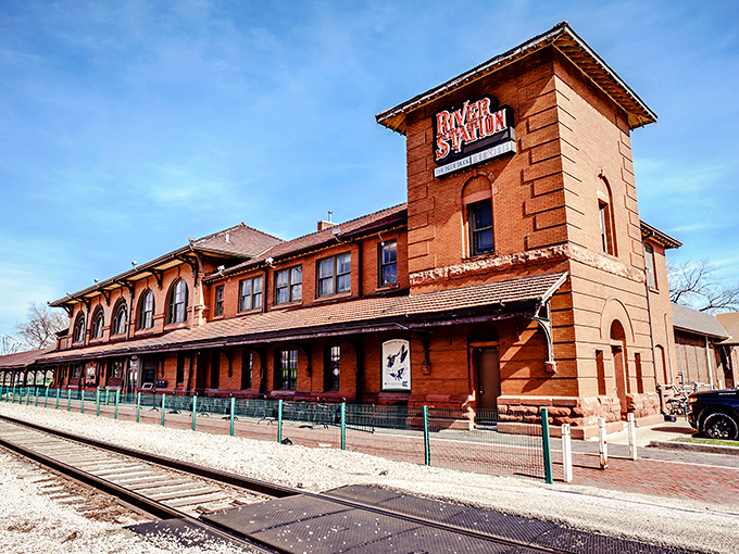 "The Pit Rib House" sign stands proud against the blue sky, like a meaty lighthouse guiding hungry sailors to smoky shores.