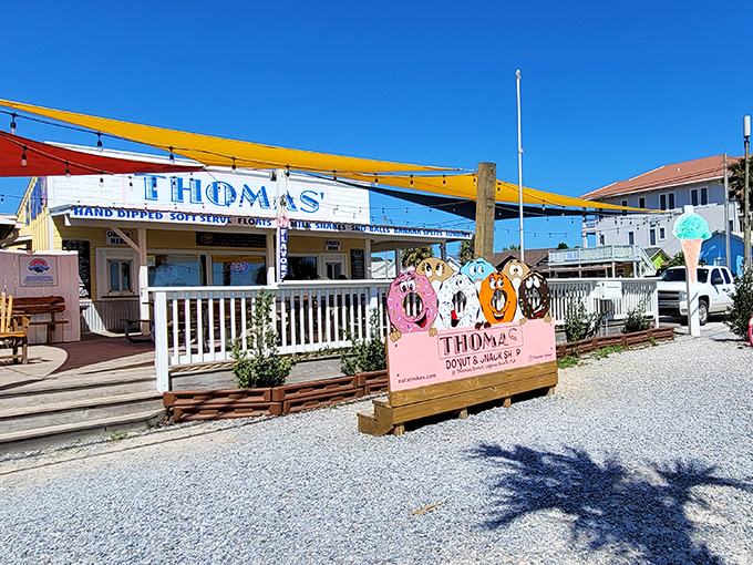 The colorful donut display out front is like a sugar-coated welcome committee for sandy feet and sunburned noses.