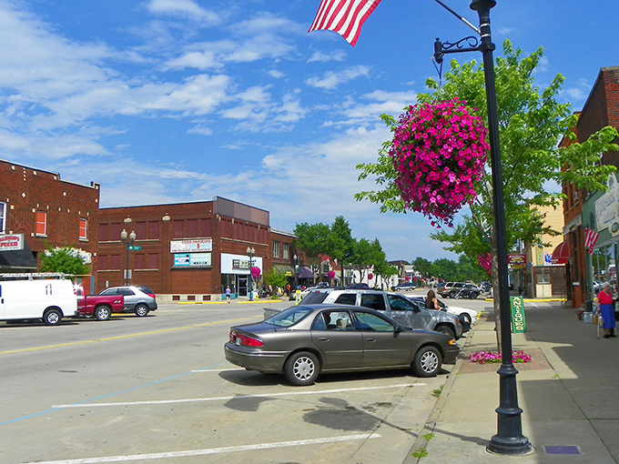 Hanging flower baskets and American flags add cheerful touches to this quintessentially Midwestern downtown scene.