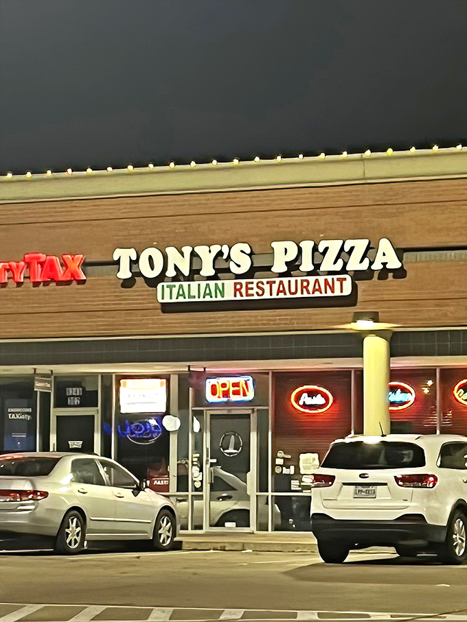 The simple storefront of Tony's Pizza & Pasta belies the Italian feast waiting inside. Fort Worth's hidden gem glows at dusk.