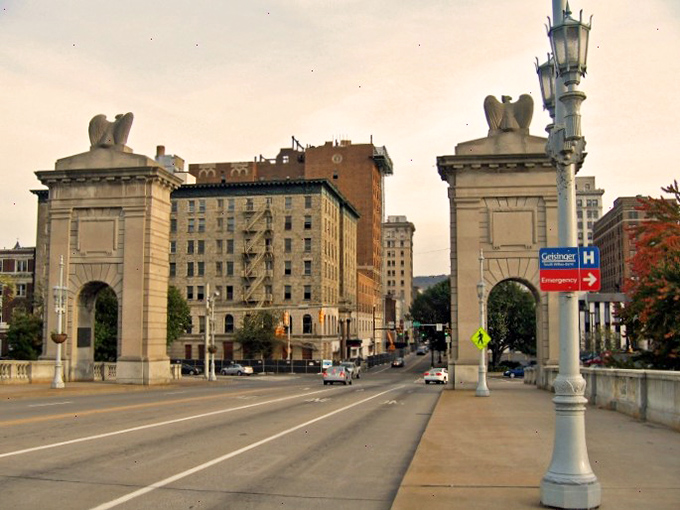 The city spreads out like a welcoming handshake between the river and the mountains.