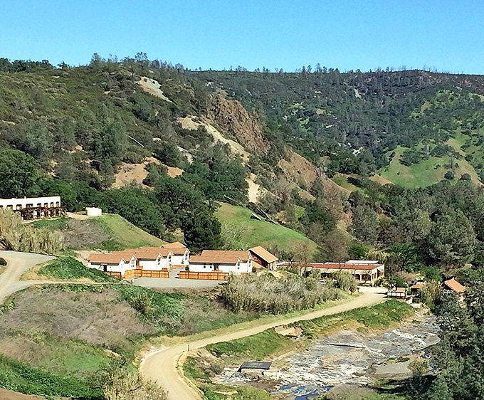 Nestled like a secret between nature's embrace! Williams' valley buildings huddle beneath dramatic, budget-friendly hillsides.