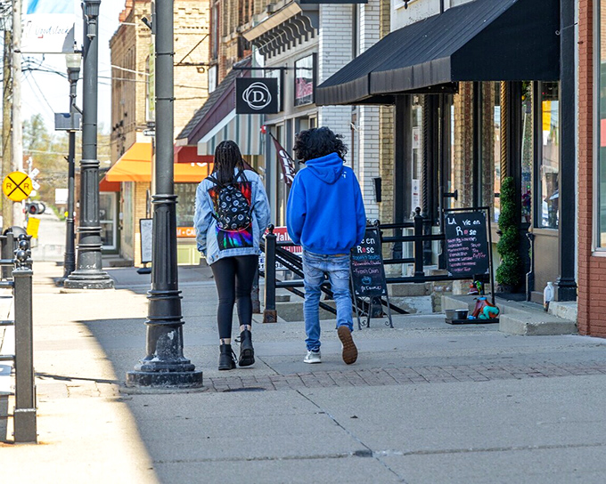People stroll along Woodstock's sidewalks, where shops housed in buildings from another era create a timeless small-town atmosphere.