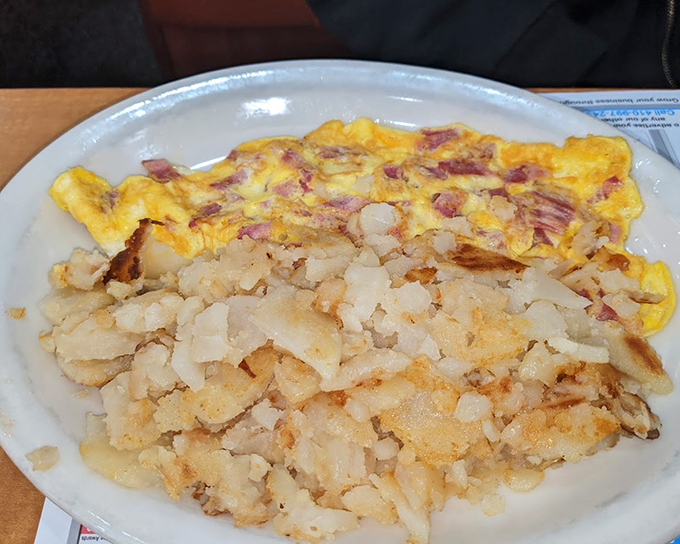 A ham and egg plate that would make Ron Swanson weep with joy, paired with hash browns that achieve the perfect crisp-to-tender ratio.