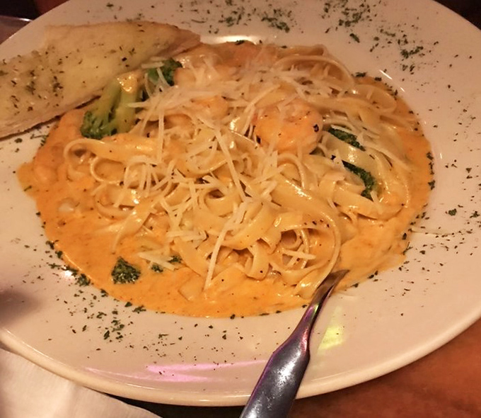 Pasta swimming in a creamy sea of alfredo sauce, where each twirl of linguine promises comfort that no trendy small plate could ever deliver.