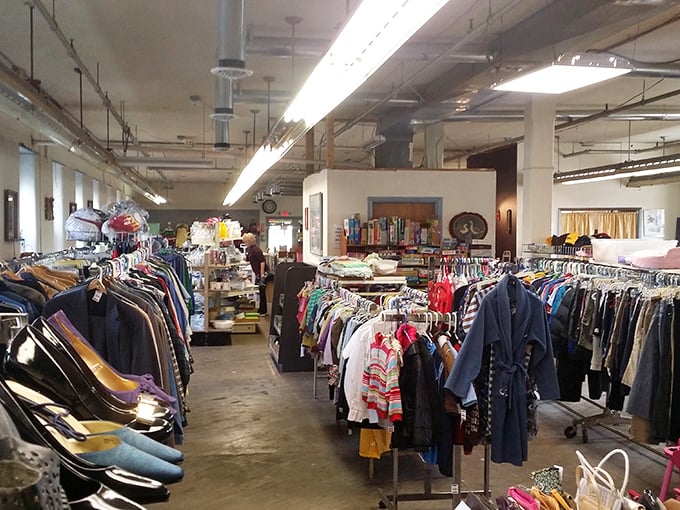 The clothing department stretches far into the distance, a textile landscape where fashion from every decade mingles in harmonious chaos.