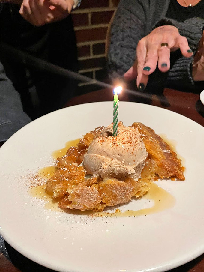 Birthday candle meets apple dessert in a moment of pure joy. That cinnamon-dusted ice cream melting into warm apple goodness is worth celebrating any day of the year.