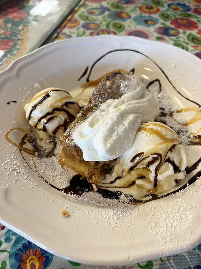 Dessert that makes you want to write poetry – warm apple pie crowned with ice cream and whipped cream, drizzled with chocolate for good measure.