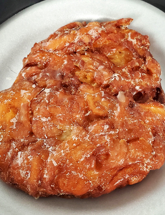 The apple fritter: where fruit meets fryer in a relationship that would make even Romeo and Juliet jealous of its passionate perfection.