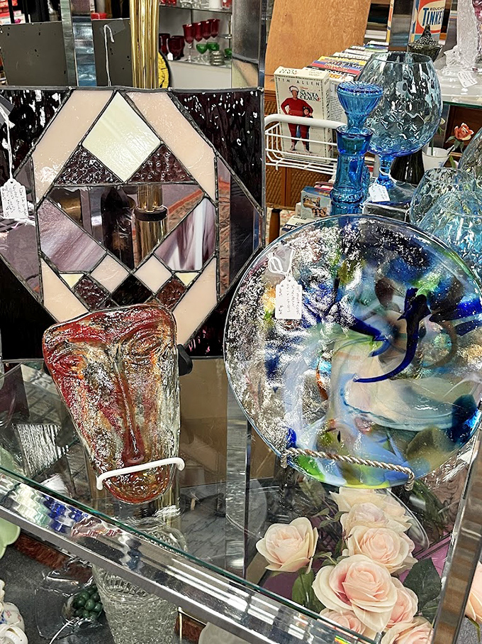 Stained glass meets art glass in this dazzling display. That blue swirled plate looks like it captured an ocean wave mid-crash.