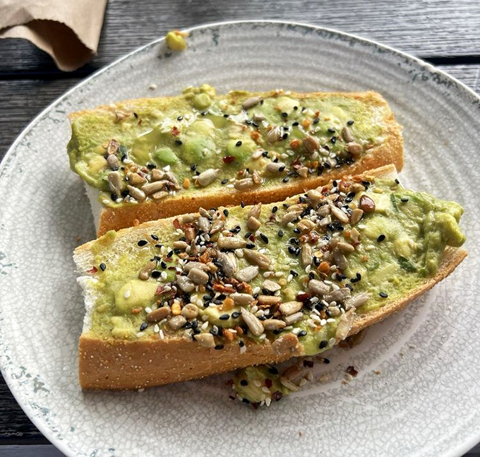 Avocado toast gets the Nashville treatment with crunchy seeds, fresh greens, and enough healthy goodness to justify the pancakes you'll order next.