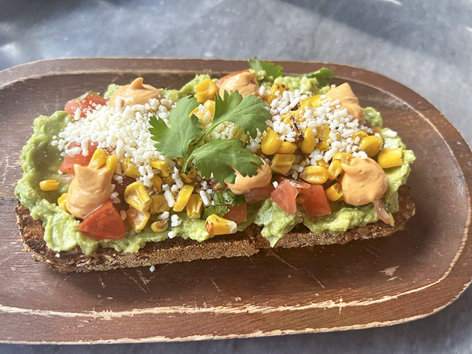 Avocado toast that makes millennials' housing decisions seem reasonable&mdash;topped with corn, cotija cheese, and enough flavor to justify the Florida sunshine.