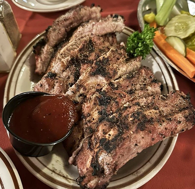 These baby back ribs wear their char marks like badges of honor, accompanied by a sauce that strikes the perfect balance between sweet, tangy, and smoky.