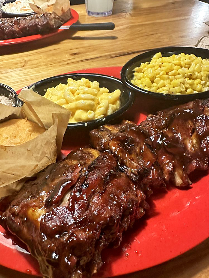 Baby back ribs glistening with sauce, flanked by mac and cheese and corn&mdash;a trio so perfect they could headline at the Grand Ole Opry.