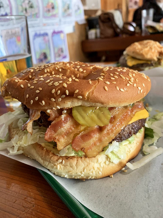 The bacon cheeseburger arrives like a beautiful, messy promise. When bacon cascades down the sides, you know you're in for something special.