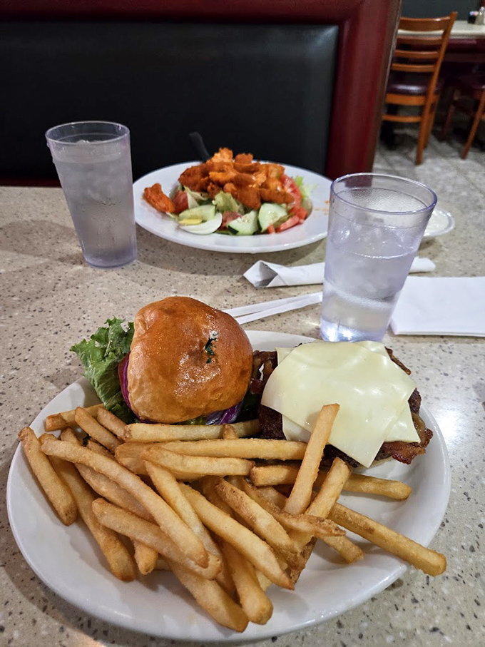 This burger isn't just a meal, it's an architectural achievement. The melted cheese cascading down the sides is pure edible art.