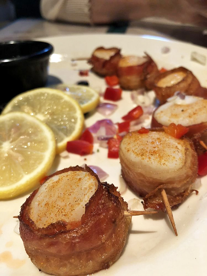 Bacon-wrapped scallops: where land meets sea in perfect harmony, each bite a testament to the simple genius of wrapping seafood in pork.