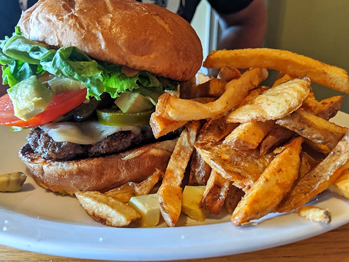 This isn't just a burger—it's architecture. The perfect stack of beef, cheese, veggies, and that golden mountain of hand-cut fries deserves its own zip code.