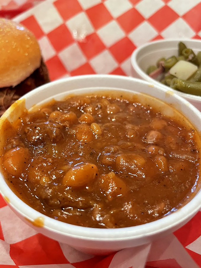 These baked beans have clearly been introduced to some smoky pork. Not your average side dish—more like a supporting actor stealing the show.
