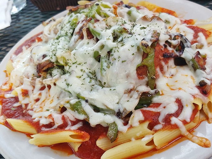 Baked mostaccioli arrives bubbling like a cheesy volcano of happiness, ready to erupt flavor all over your taste buds.