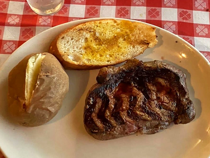 Another angle of steak nirvana. The char marks tell a story of careful grilling while the potato stands by, ready for its supporting role.