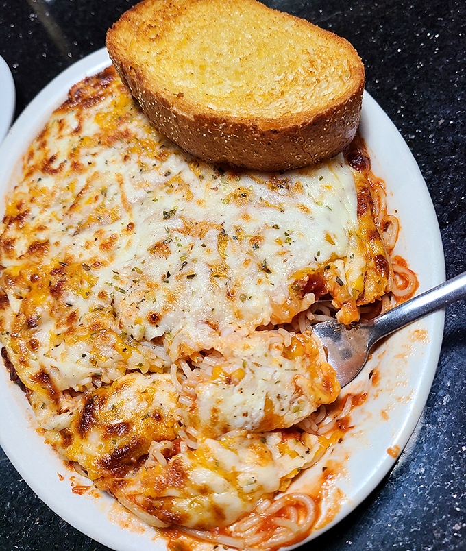 Baked spaghetti that would make an Italian grandmother nod in approval. The cheese-to-pasta ratio here is what mathematicians call "perfect."