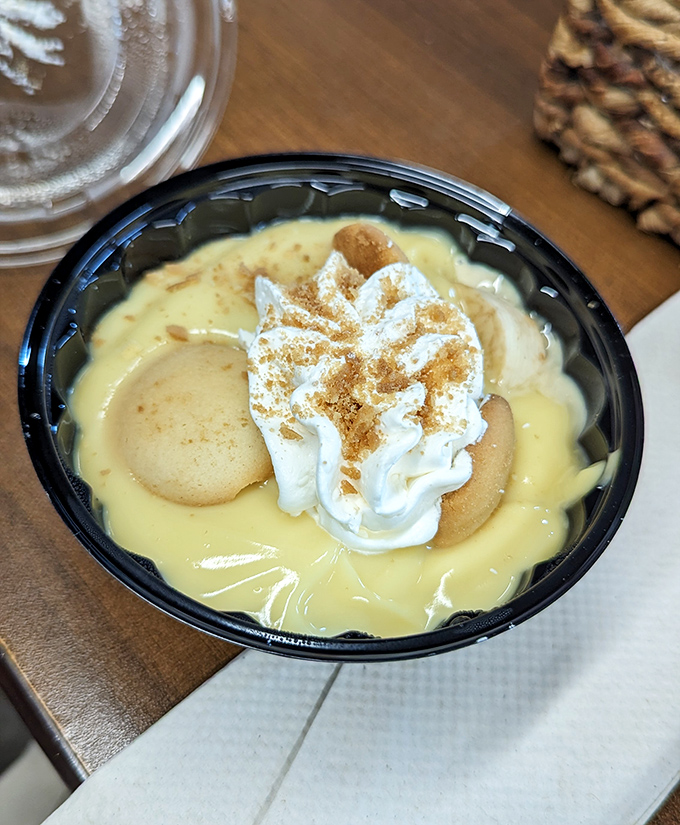 Banana pudding topped with whipped cream and vanilla wafers – the dessert equivalent of a warm Southern hug after a long, hard day.