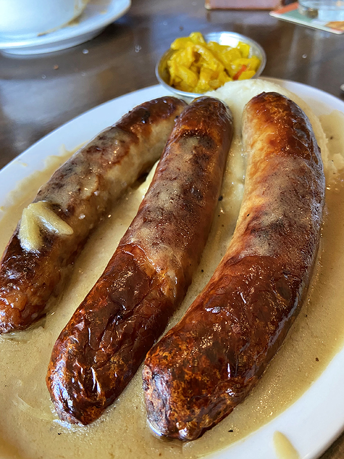 These bangers aren't just sausages; they're glistening ambassadors of Irish cuisine, lounging on a bed of gravy like they own the place.
