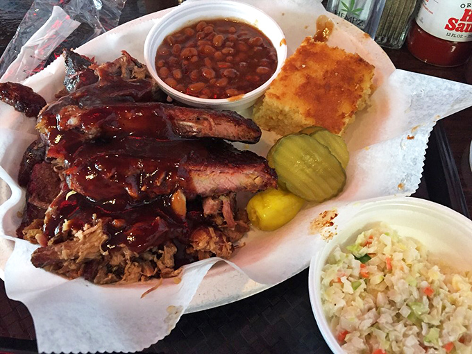 Barbecue nirvana on butcher paper &ndash; ribs, pulled meat, cornbread, and sides creating the perfect harmony. This isn't a meal; it's a symphony.