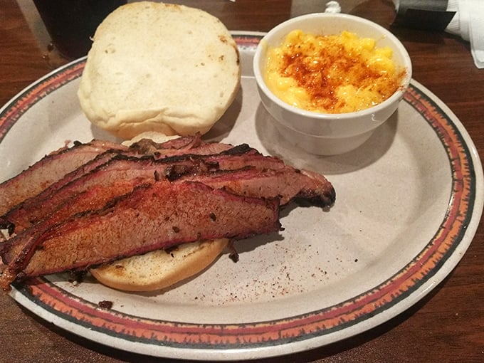 The brisket sandwich arrives with that telltale pink smoke ring—barbecue's equivalent of a Michelin star. Paired with mac and cheese that's worth every creamy, indulgent bite.