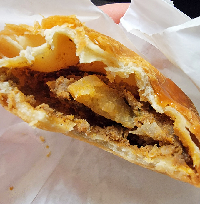 The empanada's golden shell holds secrets more delicious than anything you'll find in a fortune cookie.