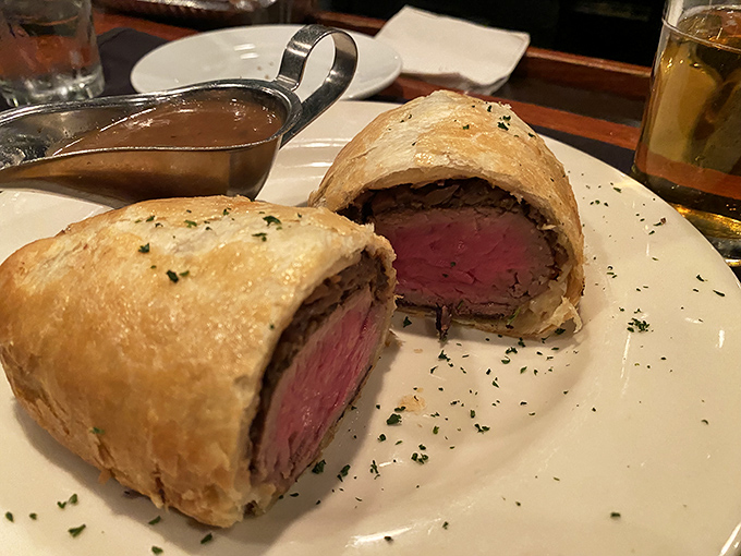 Beef Wellington: where tenderloin meets puff pastry in a relationship more perfect than any Hollywood romance. That pink center deserves its own fan club.