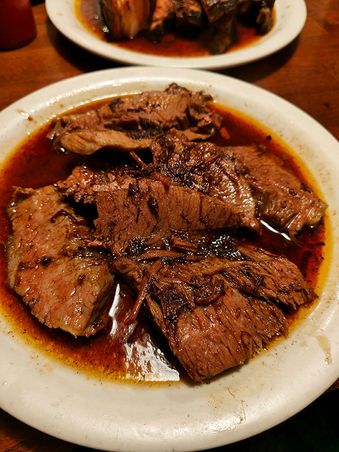 Brisket so tender it practically surrenders at the sight of your fork. That smoke ring is the BBQ equivalent of a Michelin star.