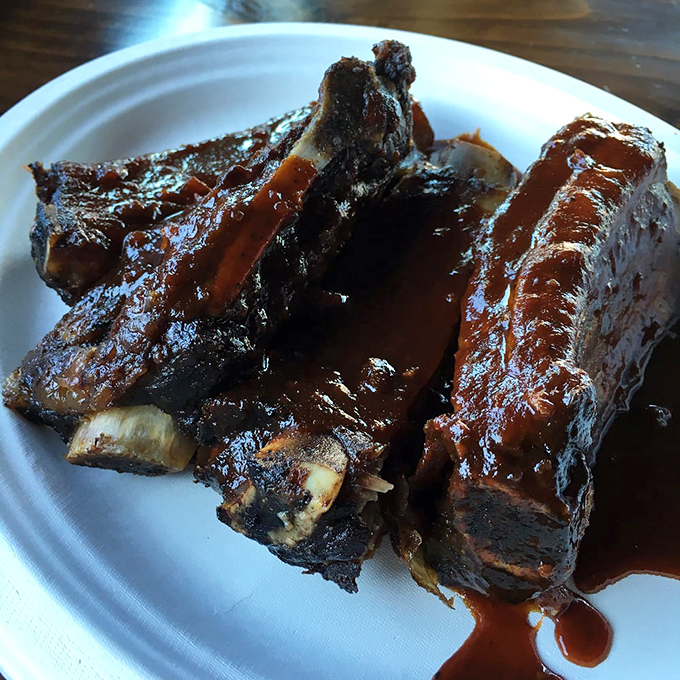 Beef ribs glistening with sauce like they've just stepped out of a BBQ fashion shoot. Carnivore couture at its finest.