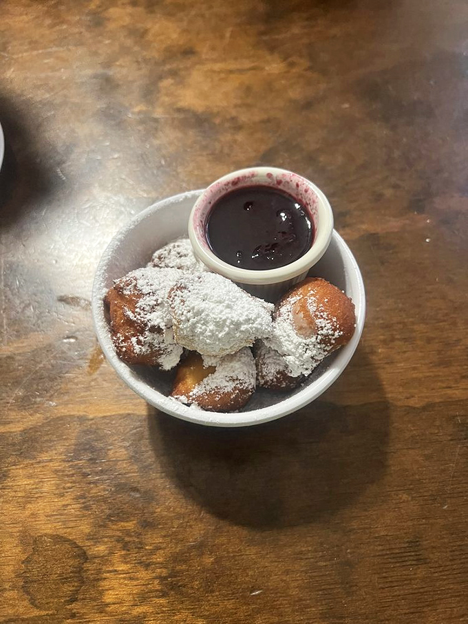 These powdered sugar-dusted beignets aren't just pastries &ndash; they're little pillows of joy with a side of berry bliss.
