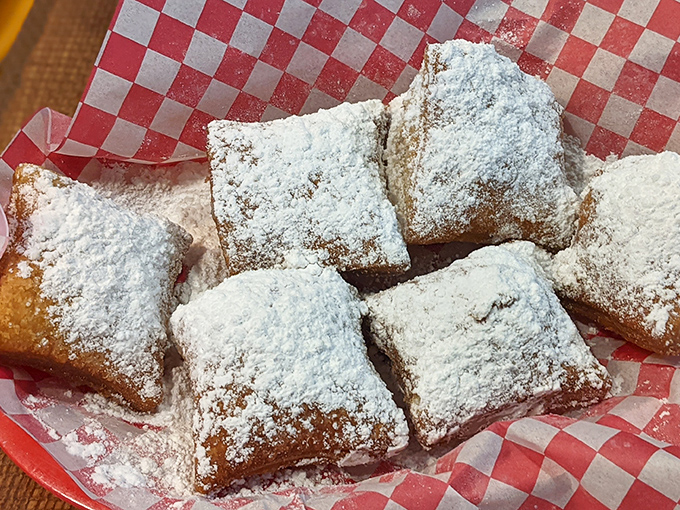 These beignets aren't just wearing powdered sugar&mdash;they're buried in a sweet avalanche that guarantees you'll leave with evidence on your shirt. Worth it.