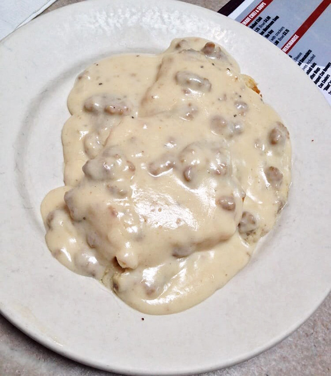 Biscuits and gravy so decadent they deserve their own zip code. That creamy sausage gravy blankets the biscuits like a Midwestern snowfall—but infinitely more welcome.