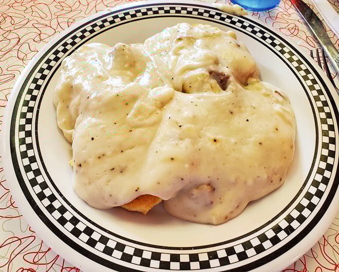 Smothered in creamy gravy that could make a vegetarian reconsider life choices, these biscuits are what morning salvation tastes like.