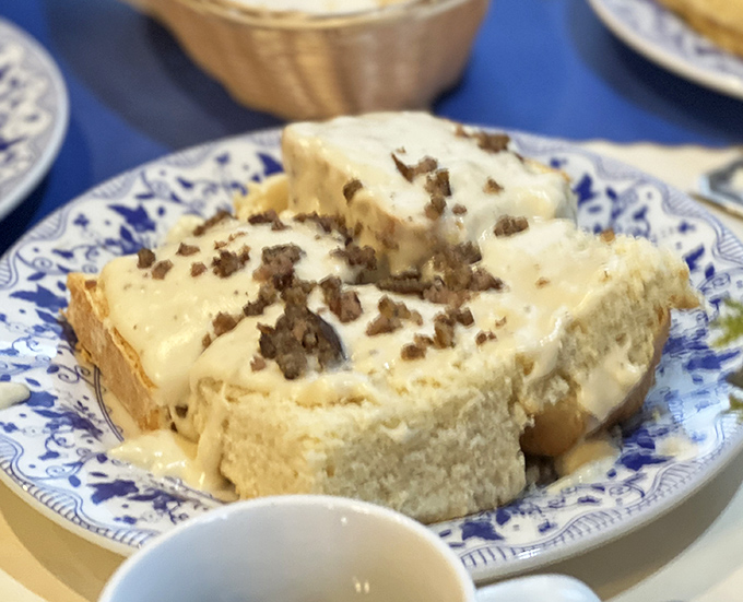 Bread pudding with sauce so good you'll contemplate drinking it straight. This isn't just comfort food—it's a warm hug on a blue and white plate.