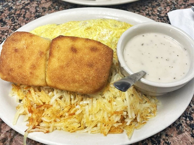 Golden biscuits nestled against crispy hash browns with gravy standing by. Some people meditate for inner peace; Texans just order this plate.