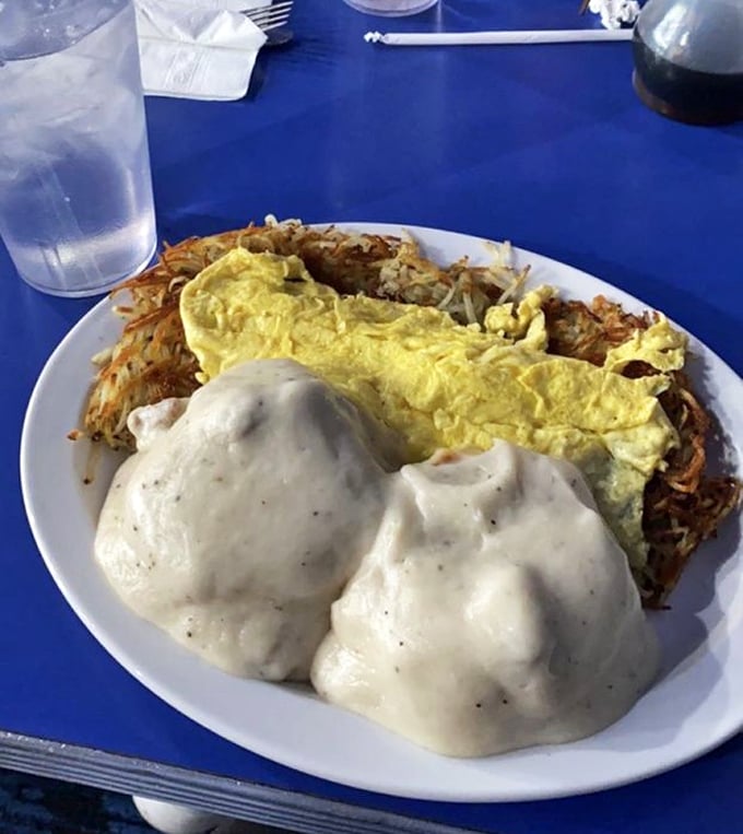 Breakfast nirvana achieved: golden eggs, perfectly crisped hash browns, and gravy that could make a vegetarian question their life choices.