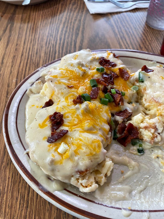 These loaded biscuits and gravy aren't messing around—crispy bacon, melted cheese, and green onions transform comfort food into an event worth photographing.