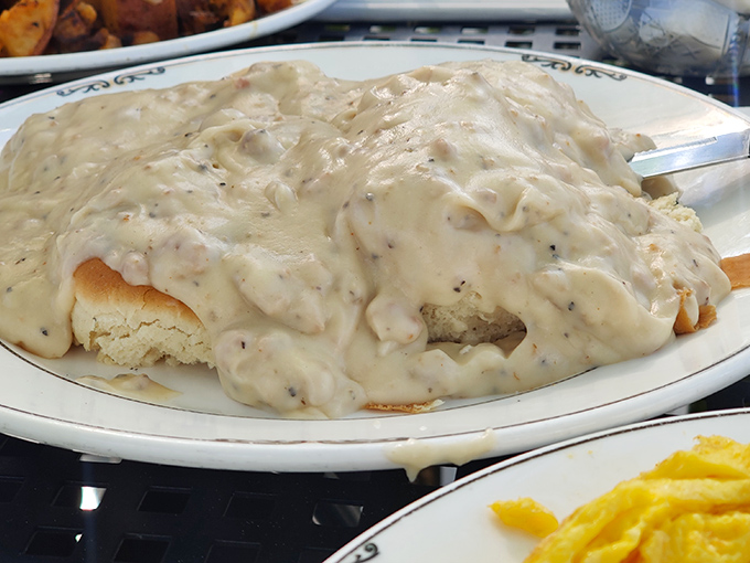 Biscuits drowning in creamy sausage gravy &ndash; a Southern classic that could make even the most dedicated health enthusiast temporarily abandon their principles for just one more bite.