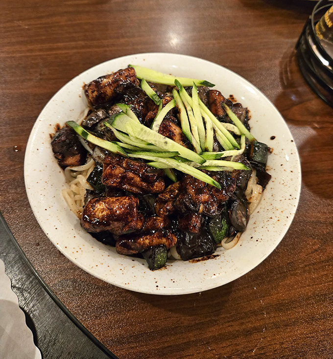 Black bean noodles topped with julienned cucumber – like a silk scarf draped over the shoulders of flavor royalty.