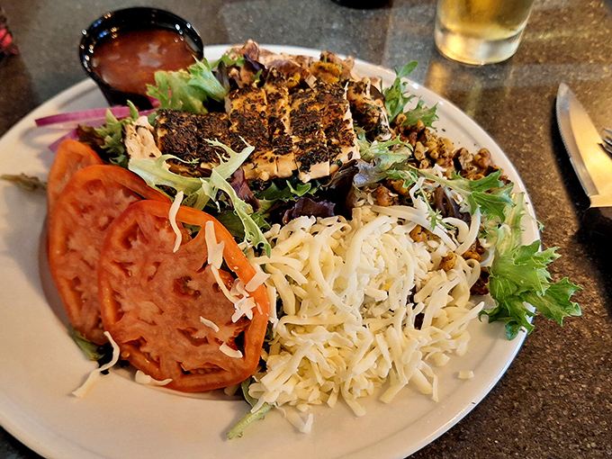 Blackened chicken with enough fresh vegetables to make your doctor write you a thank-you note. This is what salads dream of becoming when they grow up. 