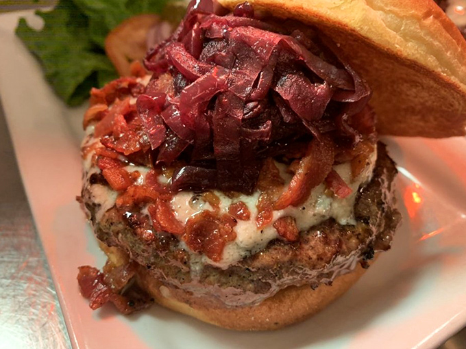 The Blue Ribbon burger stacked high with bacon and caramelized onions—this is what burger dreams are made of.